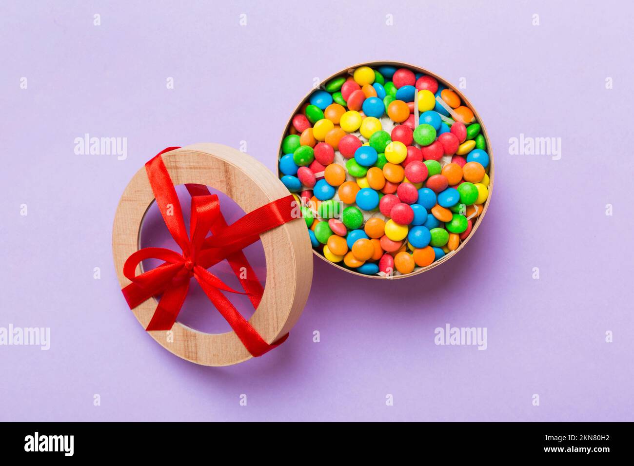 Set of different sweet candy in a paper box with a satin ribbon on a ...