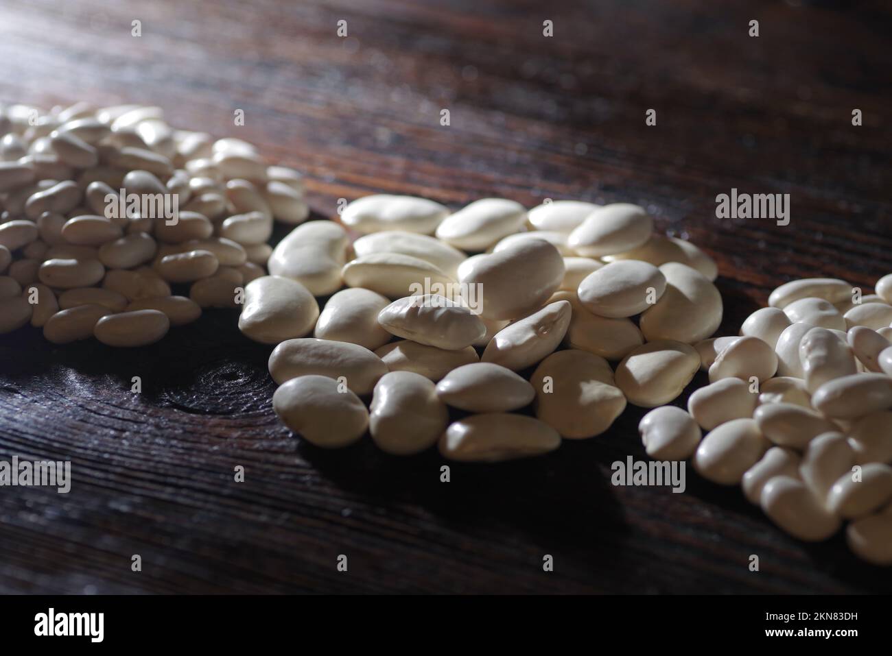 Healthy large raw husked white kidney beans scattered of evenly layer ...