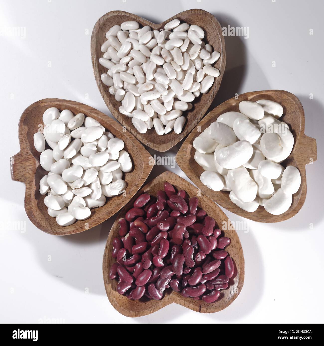 Healthy raw dried large and small white beans on a wooden dish on a ...