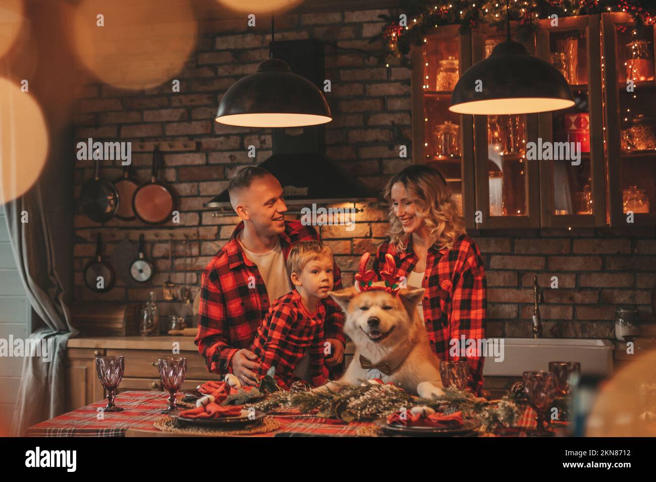 Portrait of happy family with son in red plaid pajamas laughing hugs ...