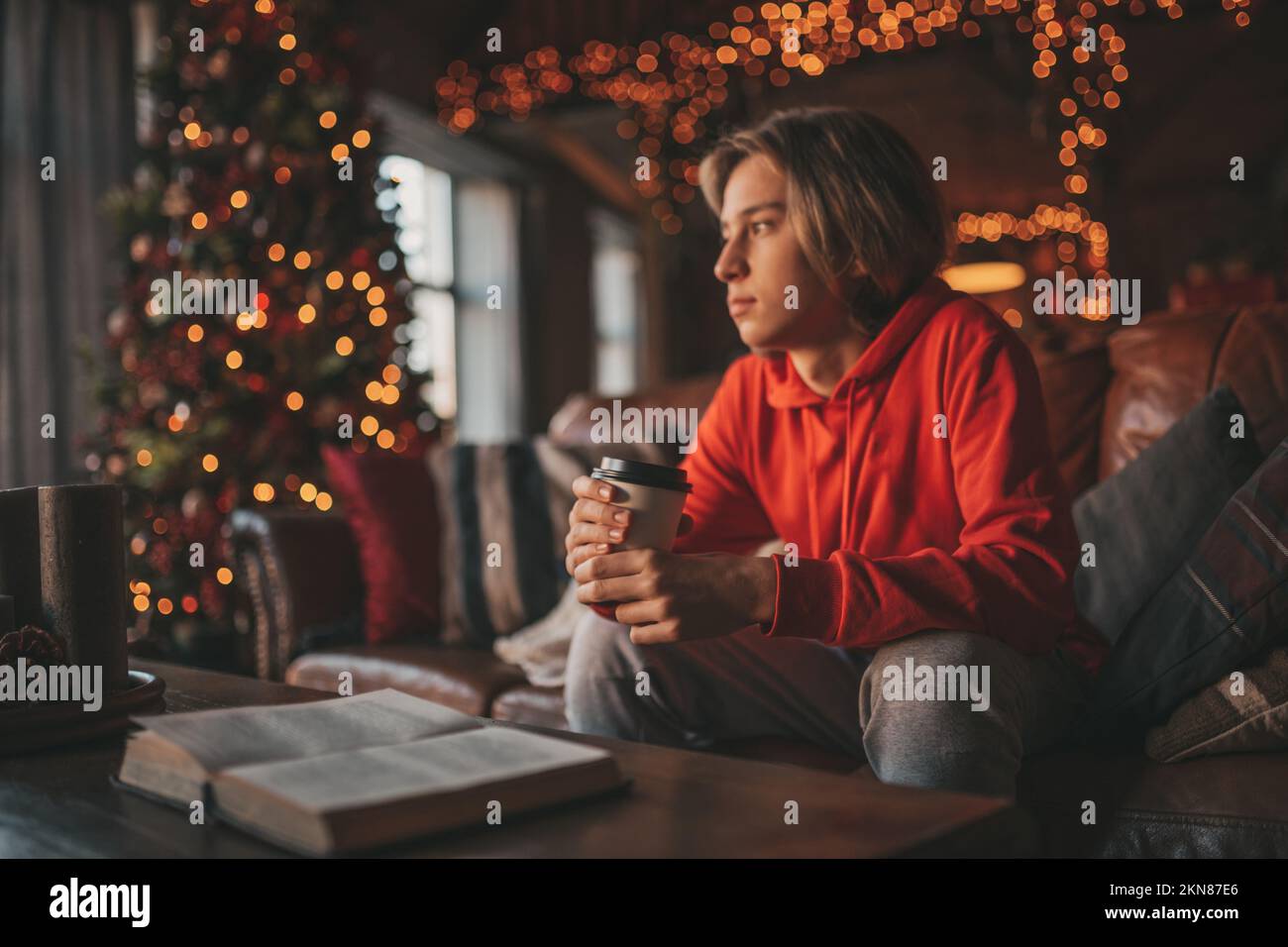 Young teen boy with long hair thoughtful look sad eyes negative mood ...