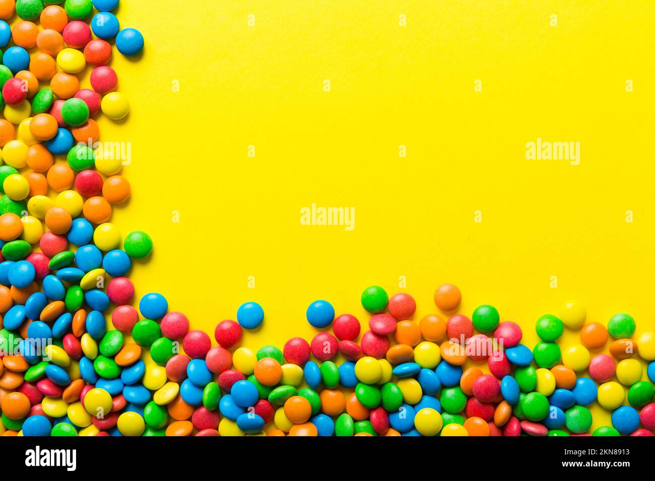Mixed collection of colorful candy, on colored background. Flat lay ...