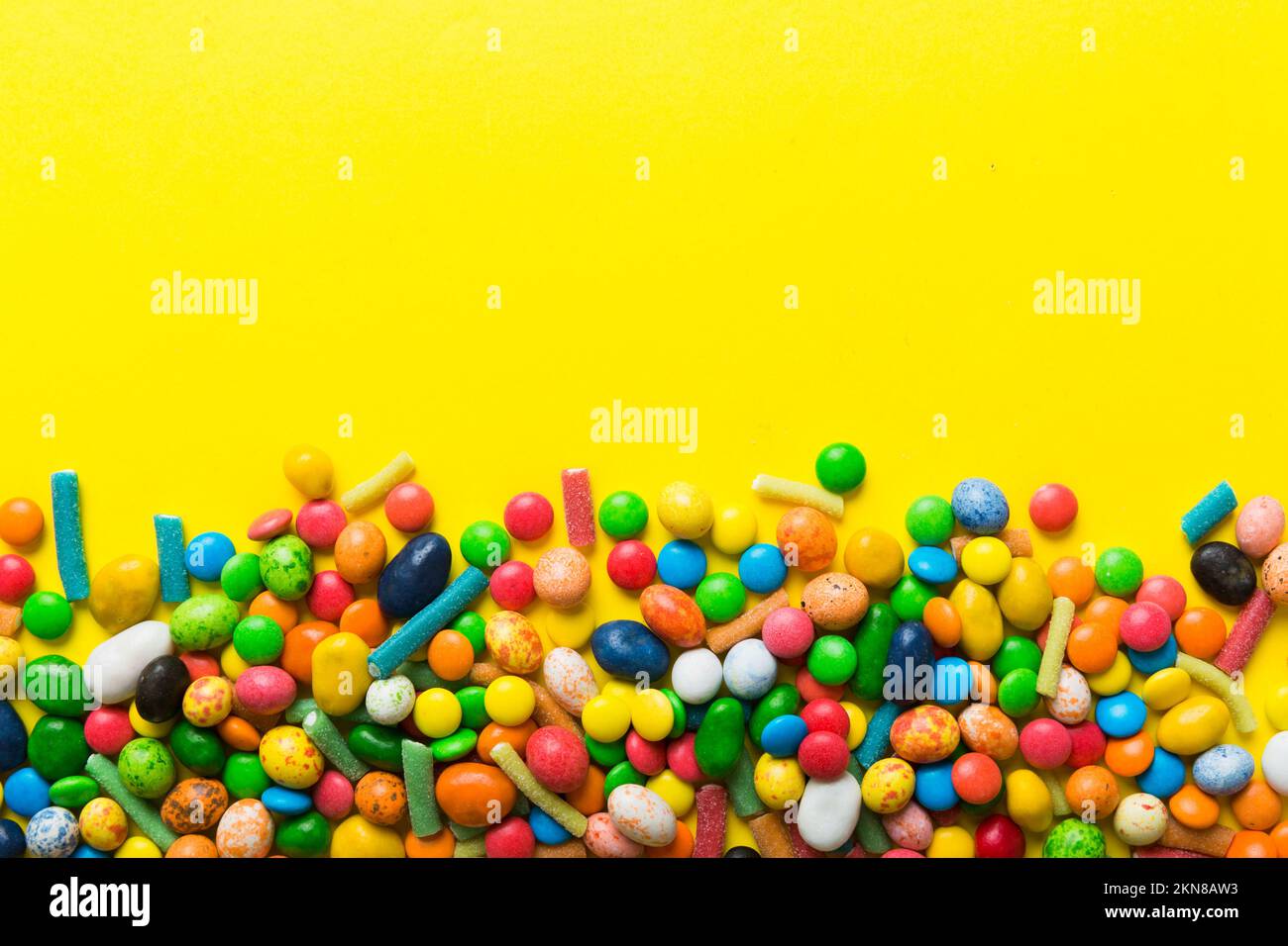 Mixed collection of colorful candy, on colored background. Flat lay ...