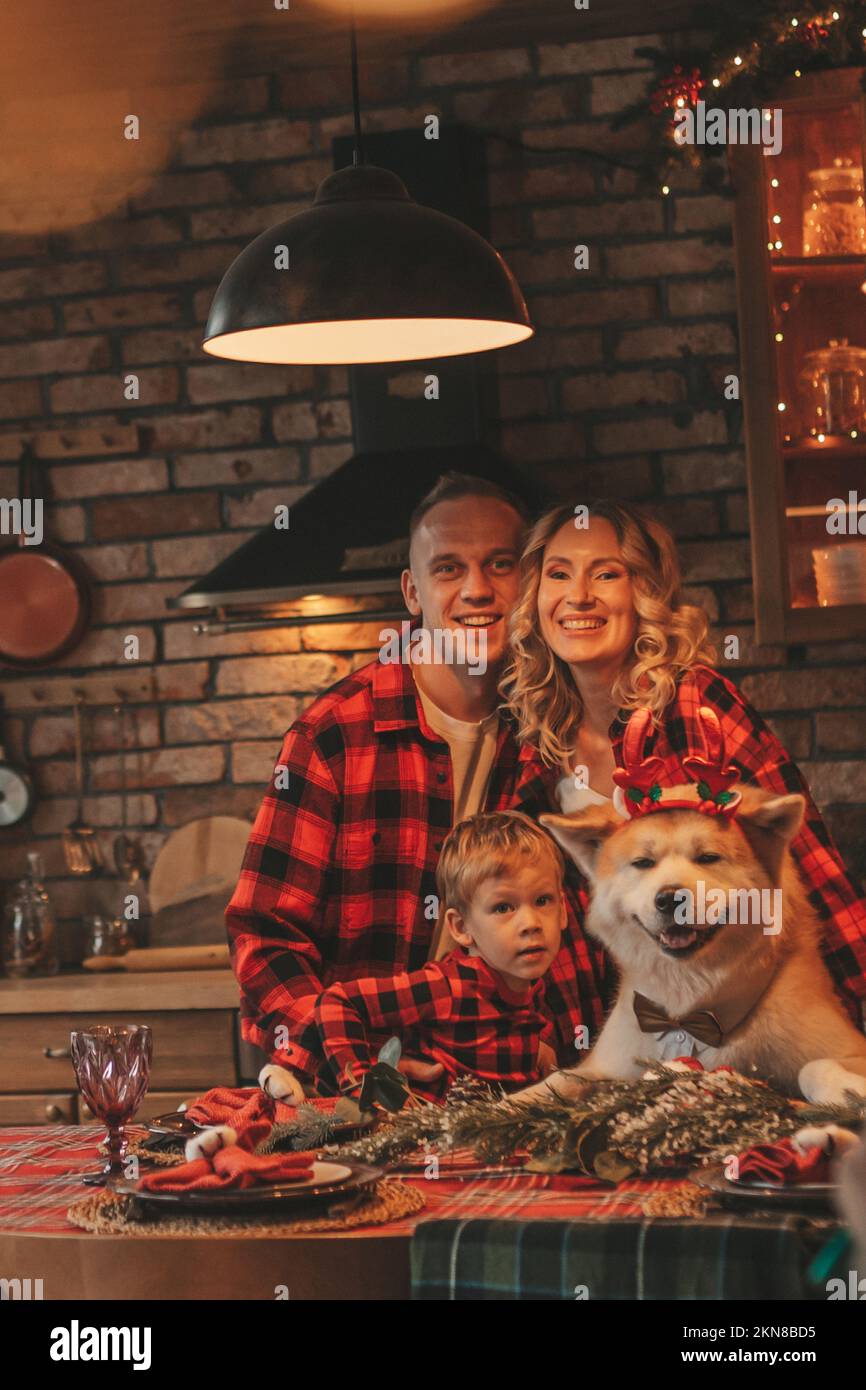 Portrait of happy family with son in red plaid pajamas laughing hugs ...