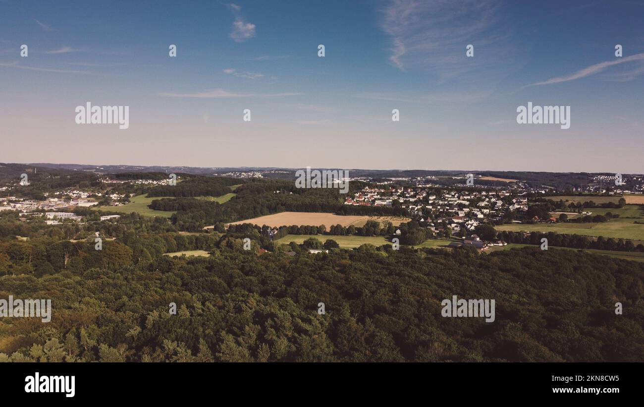 An aerial view of a small town and forest landscape in Germany under a ...