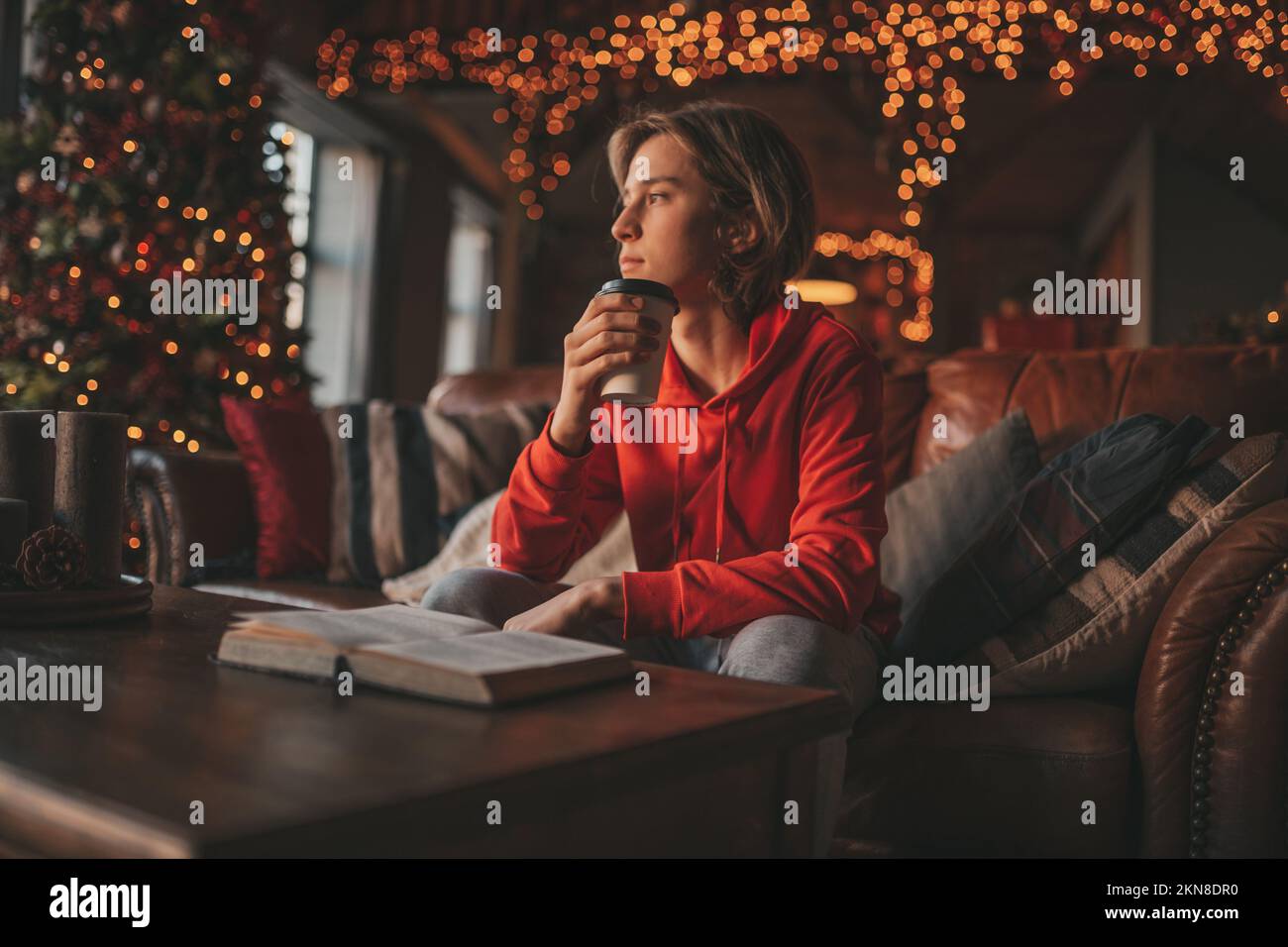 Young teen boy with long hair thoughtful look sad eyes negative mood ...
