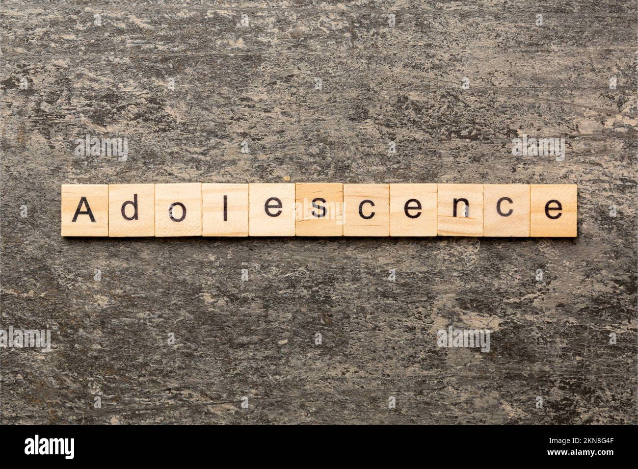 adolescence word written on wood block. adolescence text on table ...