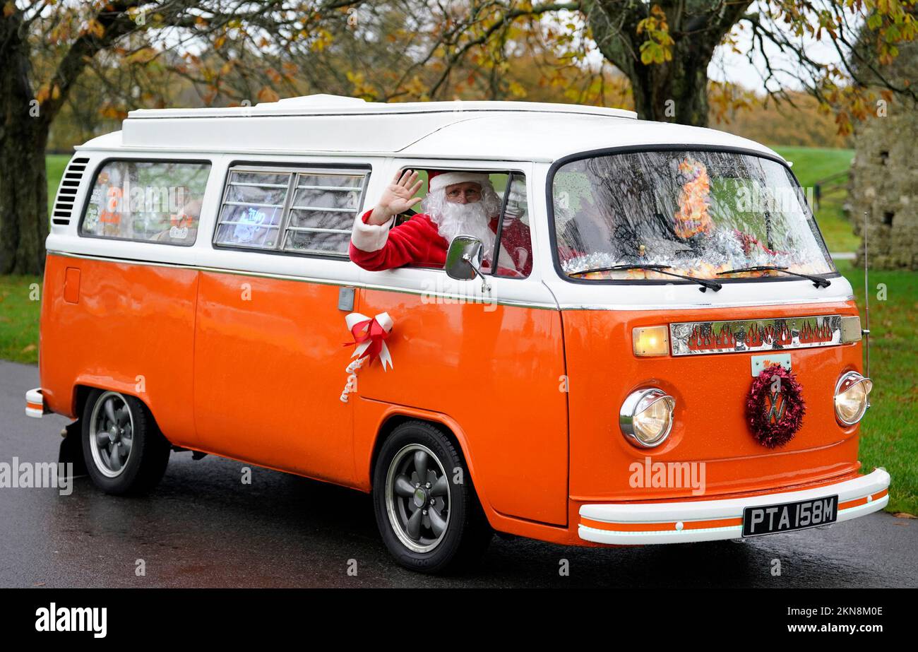 A participant dressed as Father Christmas waves from their VW Camper ...