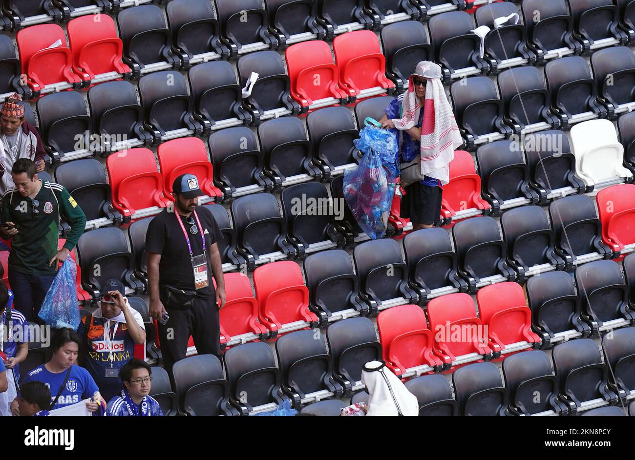 Japan fans help clear up litter in the stands after the FIFA World Cup ...
