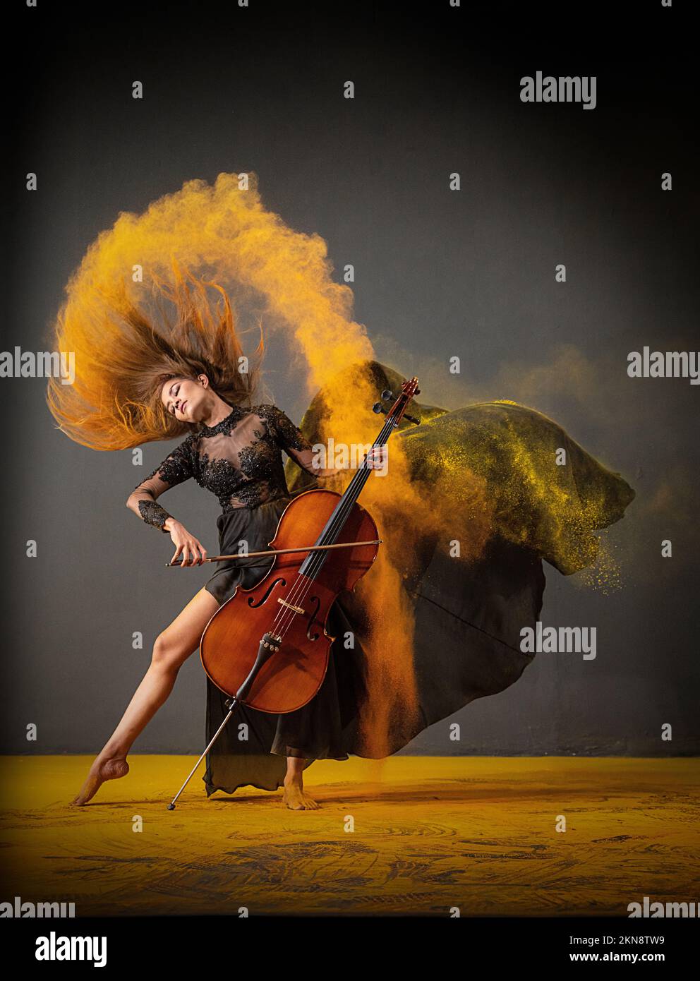 A Southeast Asian woman playing cello with yellow powder on her hair ...