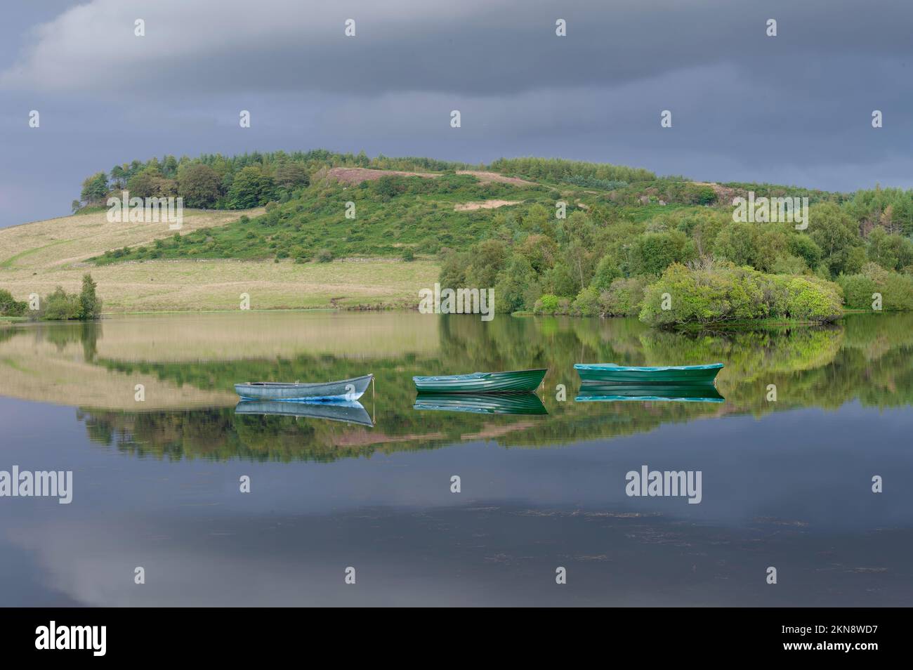 Fishing boats in lake and early morning mist with boats in background ...