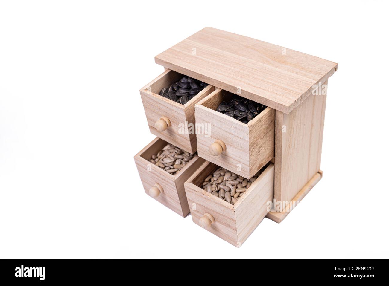 Wooden box cells filled with various spices. wooden box with sunflower ...