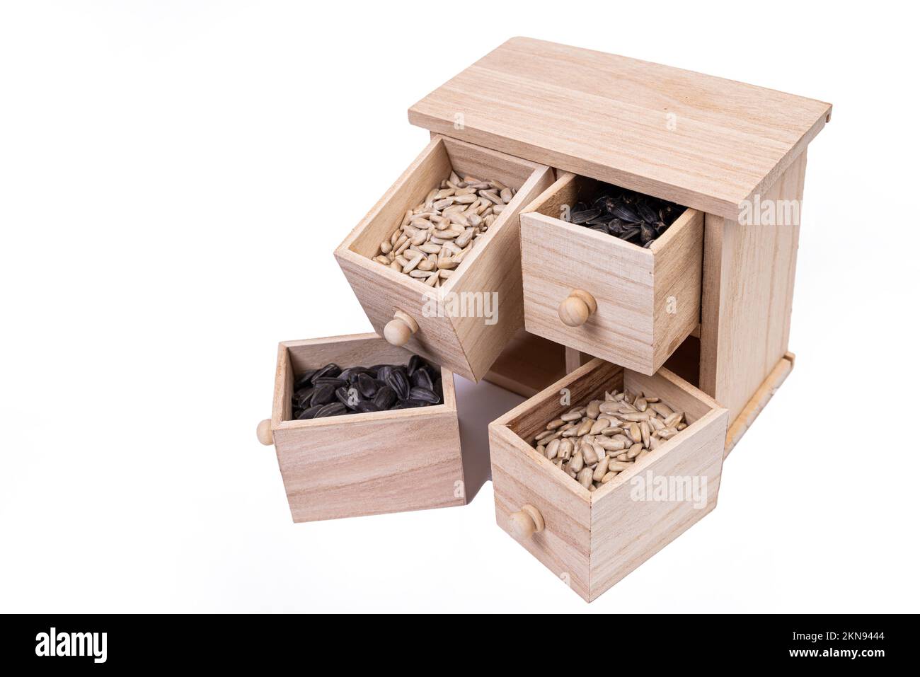 Wooden box cells filled with various spices. wooden box with sunflower ...