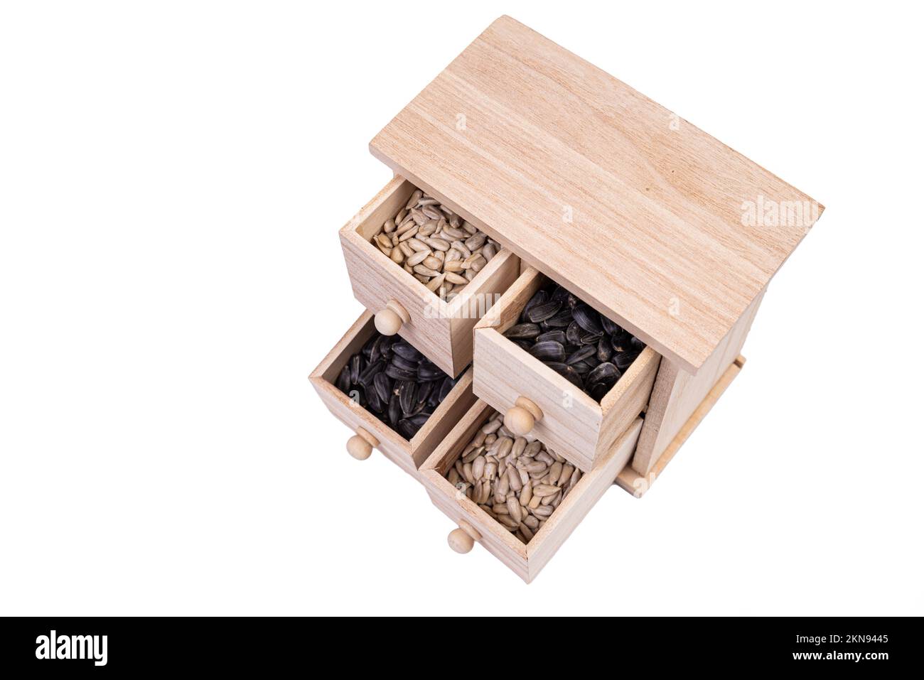 Wooden box cells filled with various spices. wooden box with sunflower ...
