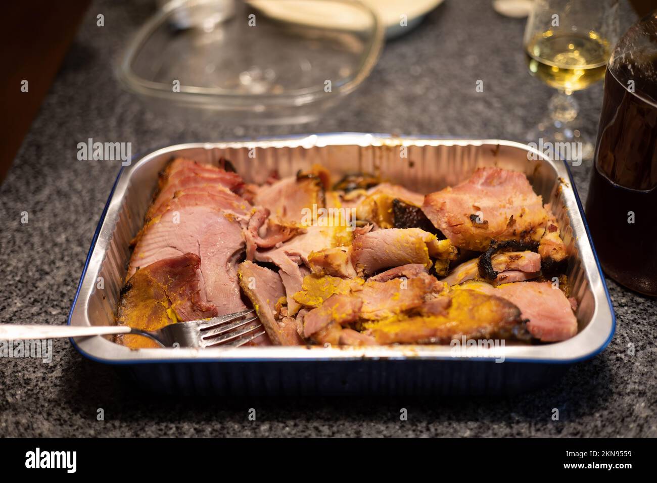 a roasted ham in a pan all ready for serving at a family gathering ...