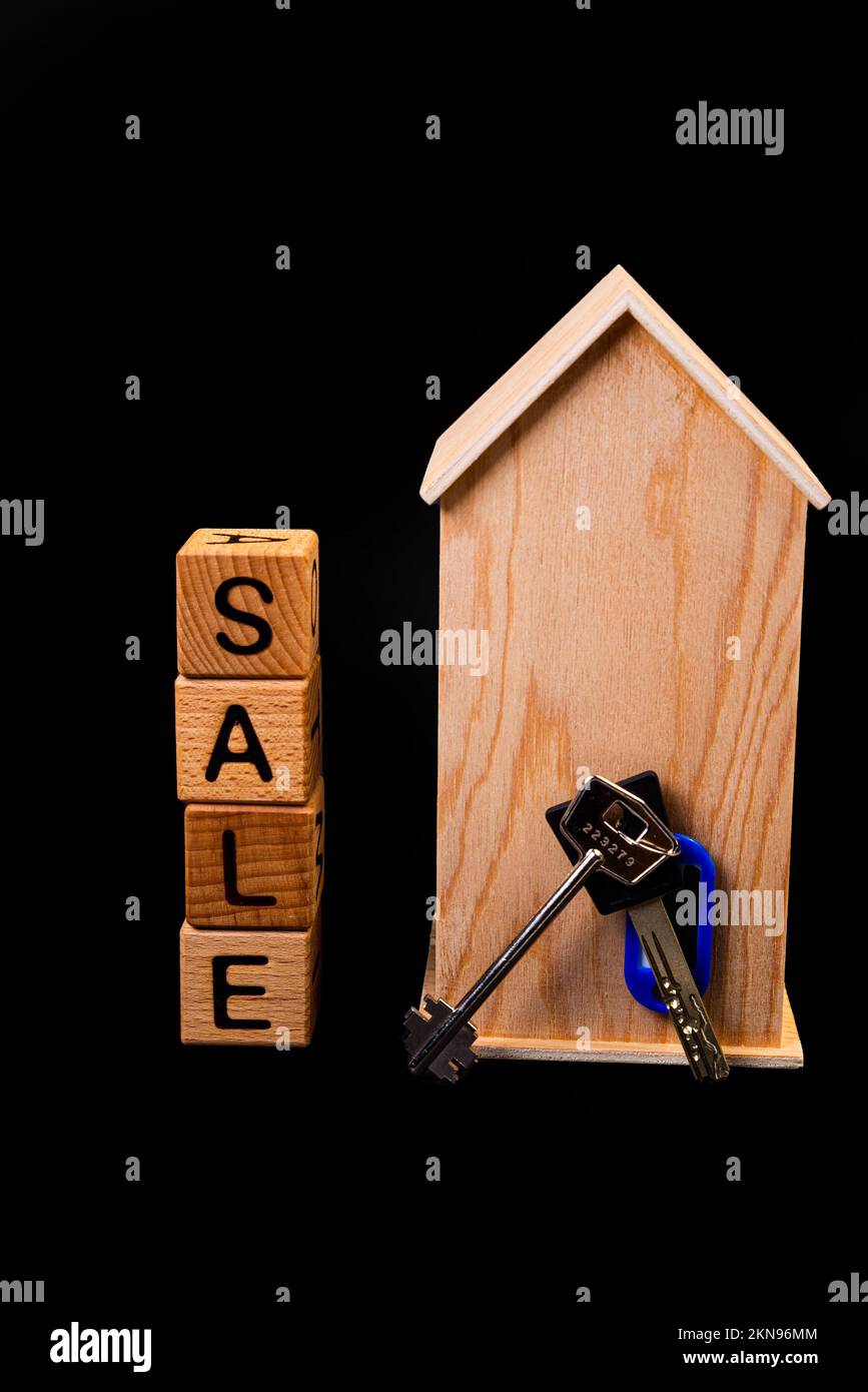 wooden house mockup with house keys, wooden cubes with words rent sale ...