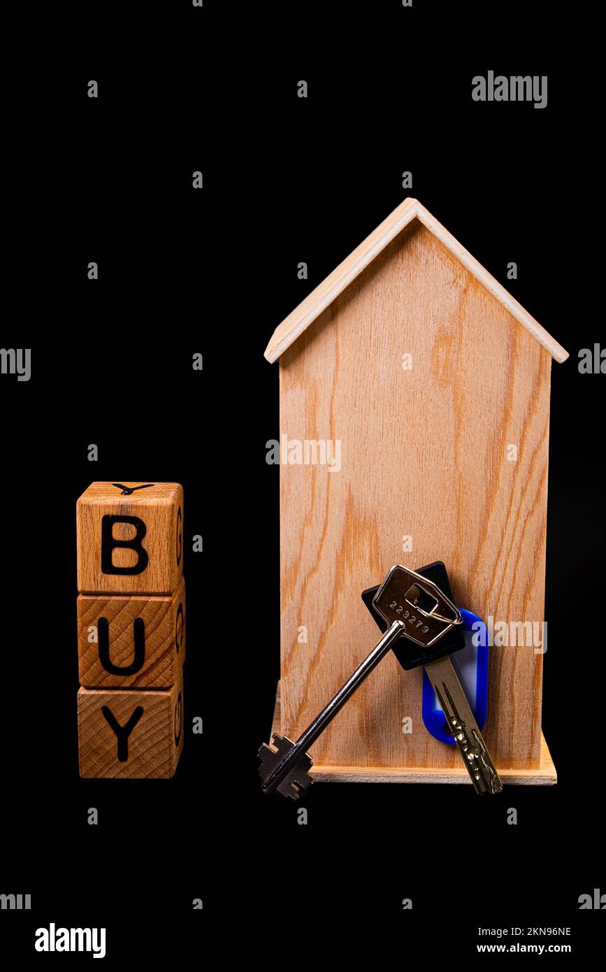 wooden house mockup with house keys, wooden cubes with words rent sale ...
