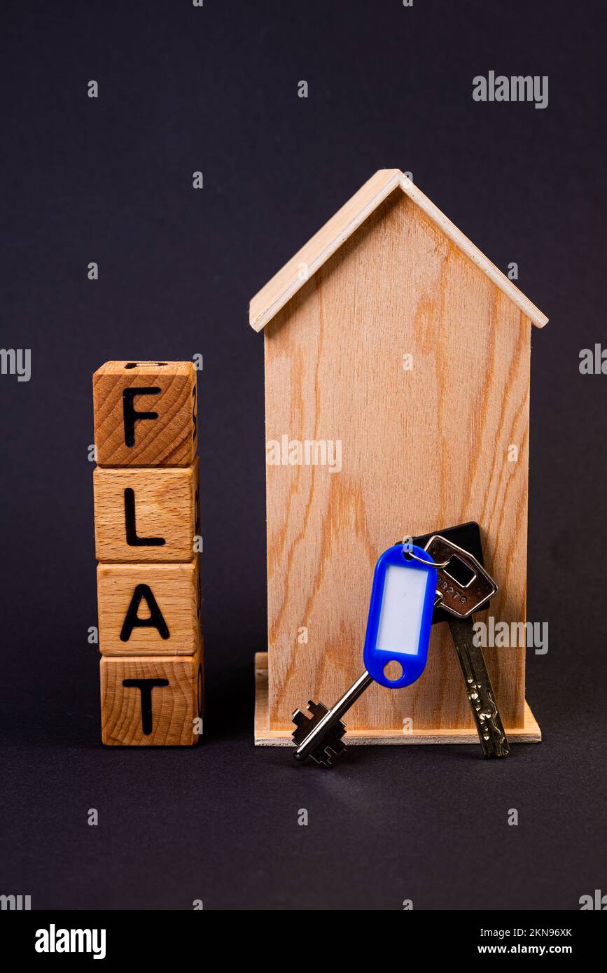 wooden house mockup with house keys, wooden cubes with words rent sale ...