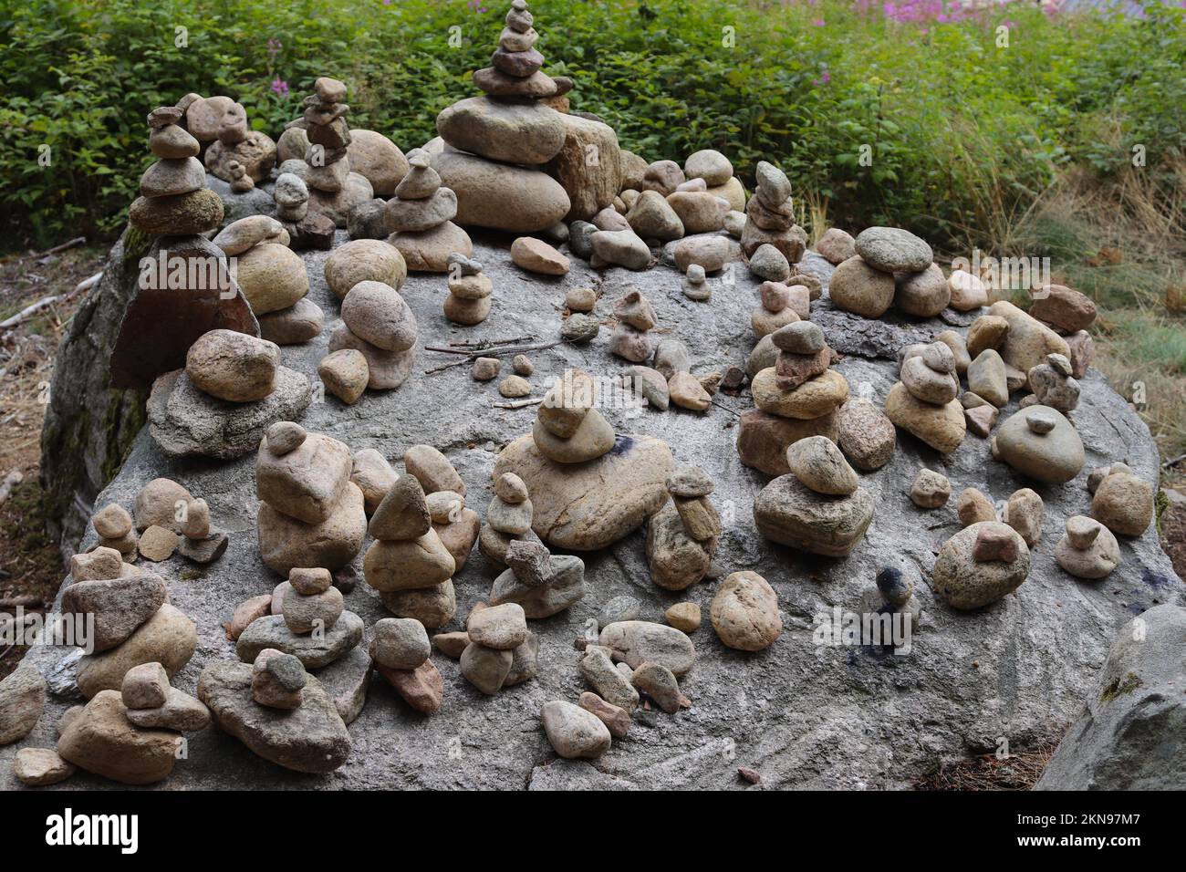Many balancing stones stacked on a big stone Stock Photo - Alamy