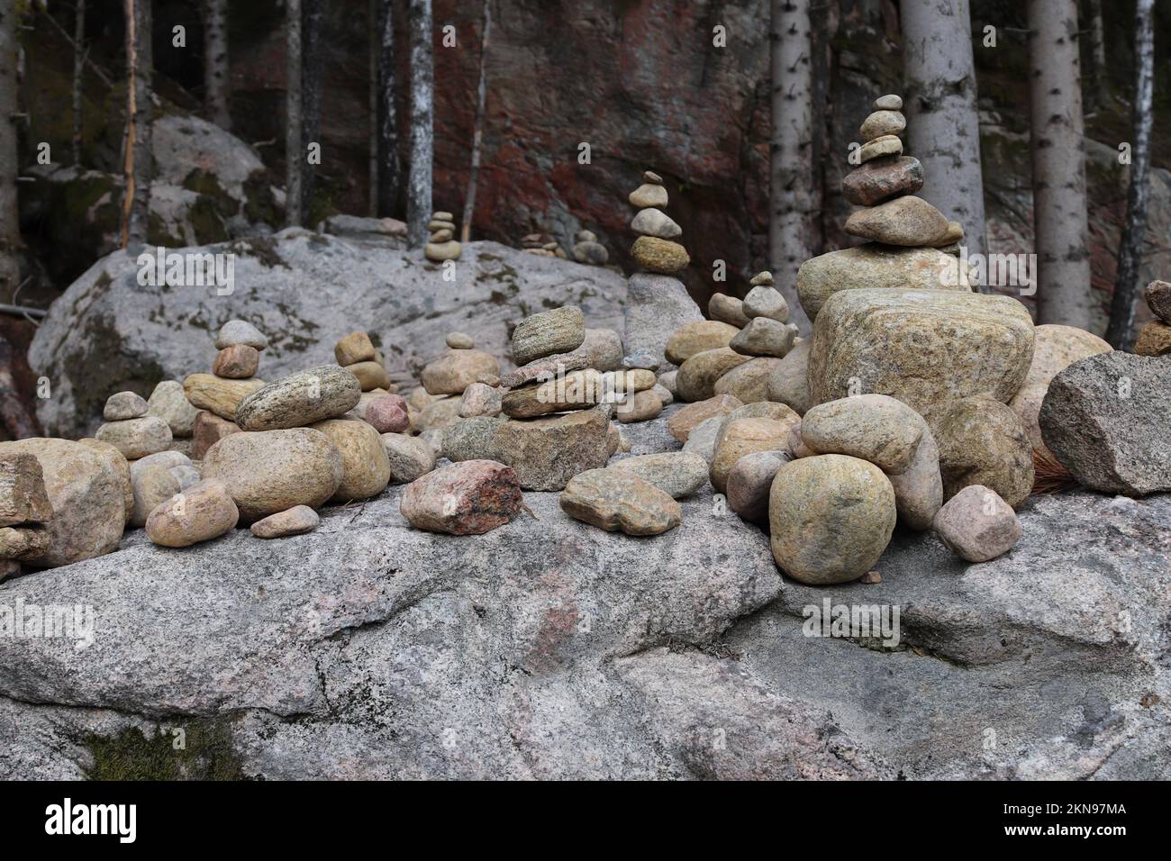 Many balancing stones stacked on a big stone Stock Photo - Alamy