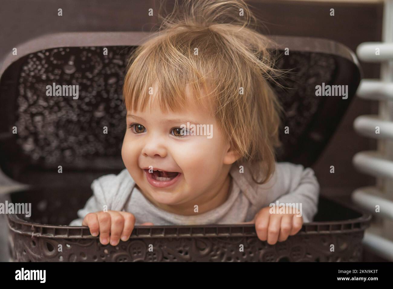 adorable baby hiding in a laundry basket Stock Photo - Alamy