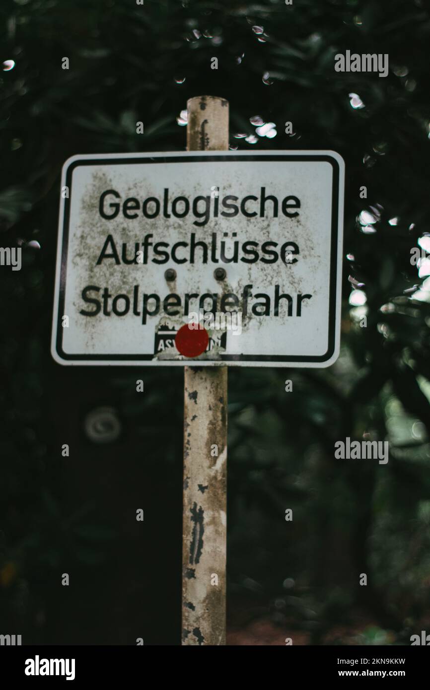 A vertical shot of a tripping hazard sign in a forest in Germany Stock ...