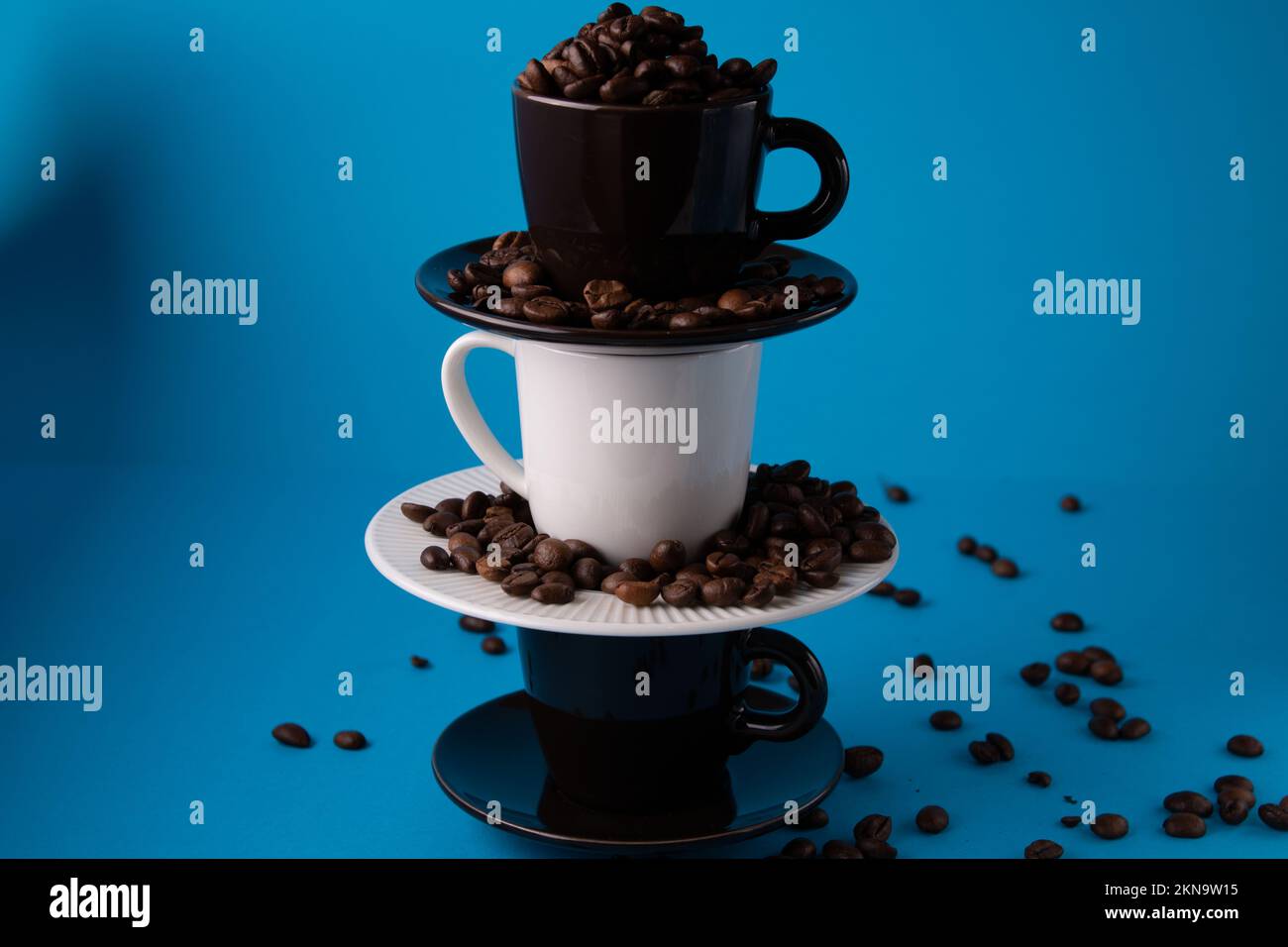 photo of coffee beans and cups in a vertical row Stock Photo - Alamy