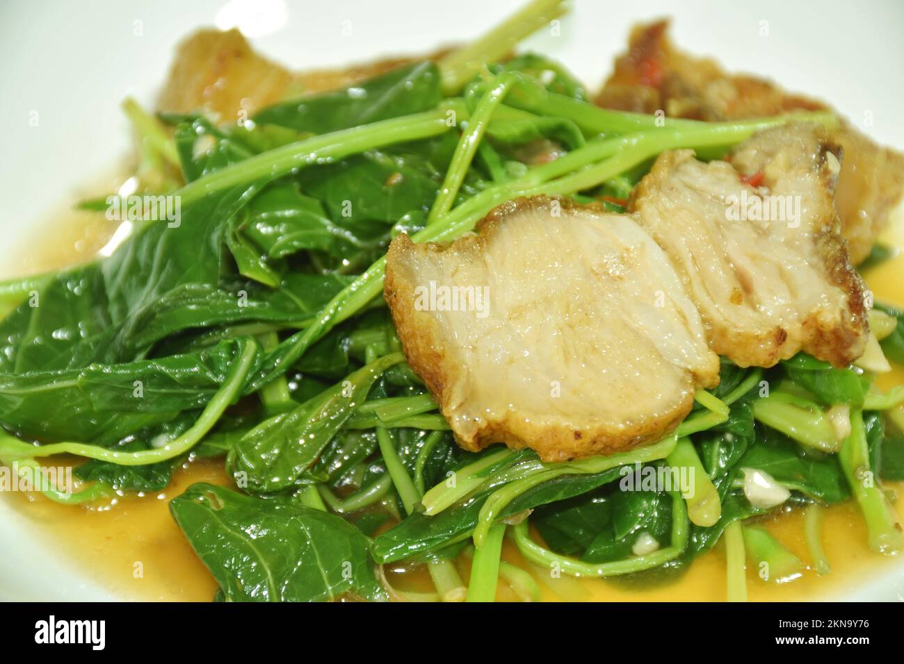 spicy fried Chinese kale with slice crispy pork in soybean and oyster ...