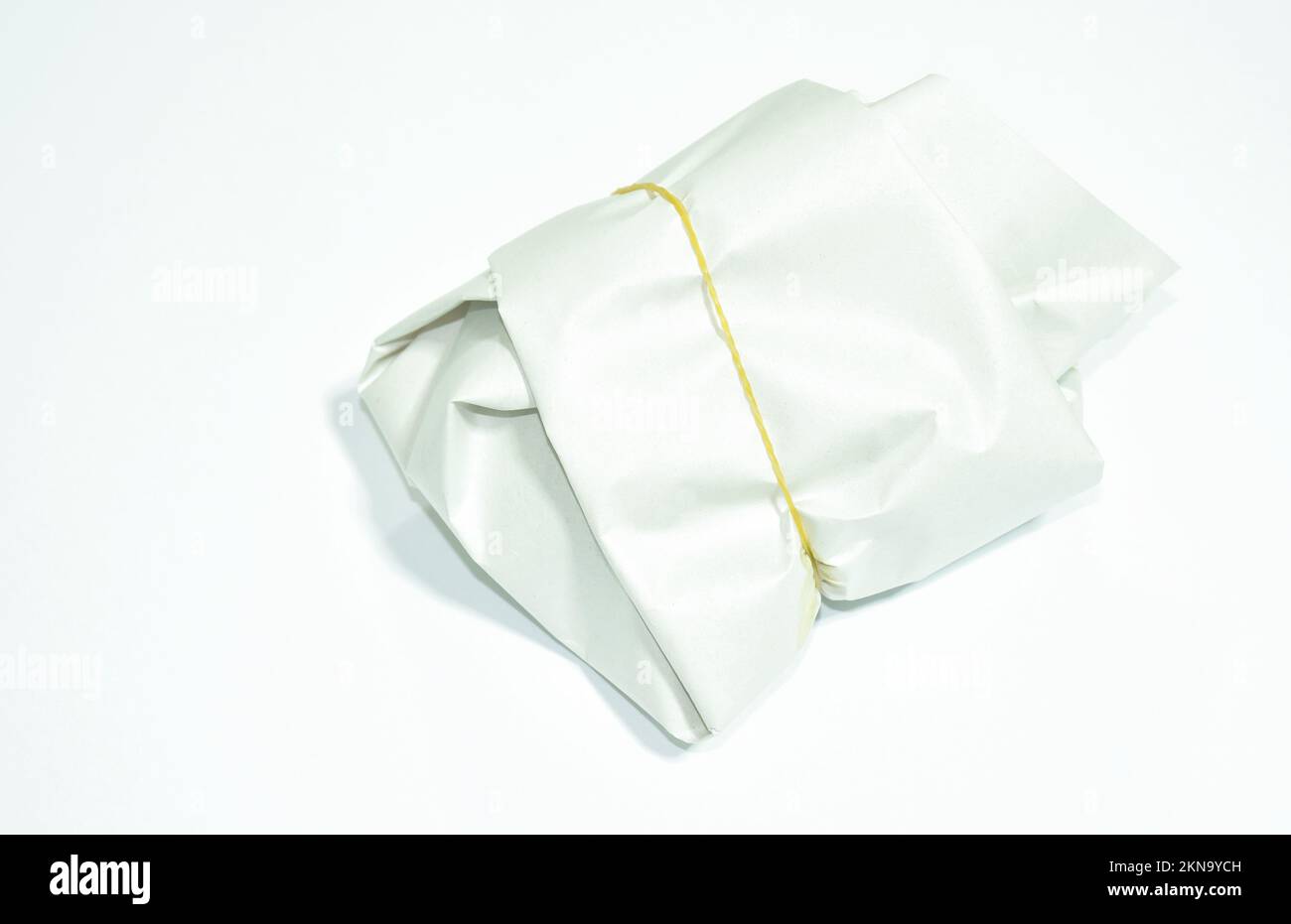 ready meal in paper packing by rubber band on white background Stock ...