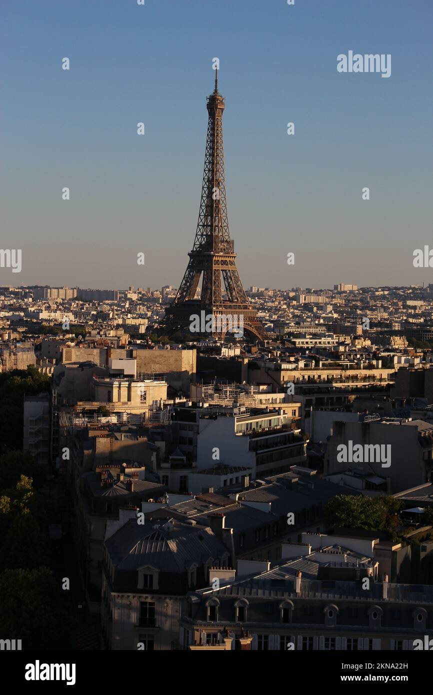 Eiffel tower at golden hour seen among the built up urban Parisian ...