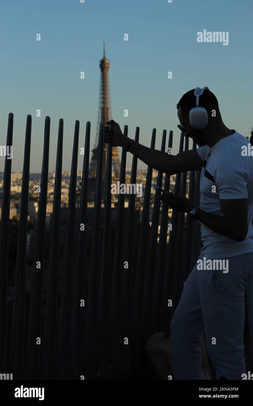 Person listening to music atop the arc de triomphe with soft focus ...