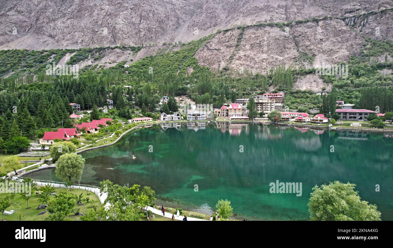 An aerial view of waterside town buildings and trees before the ...