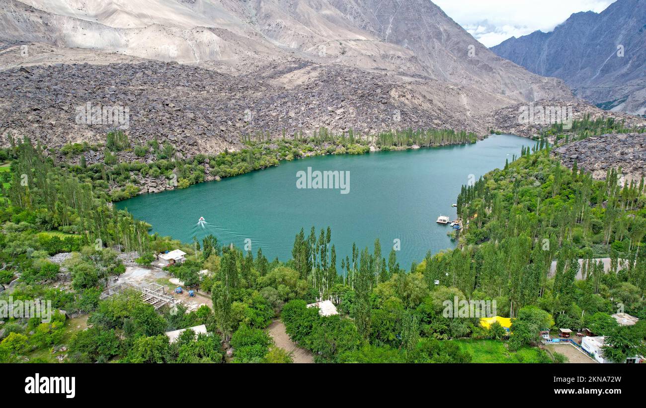 An aerial view of a town with trees by the lake before the valley Stock ...