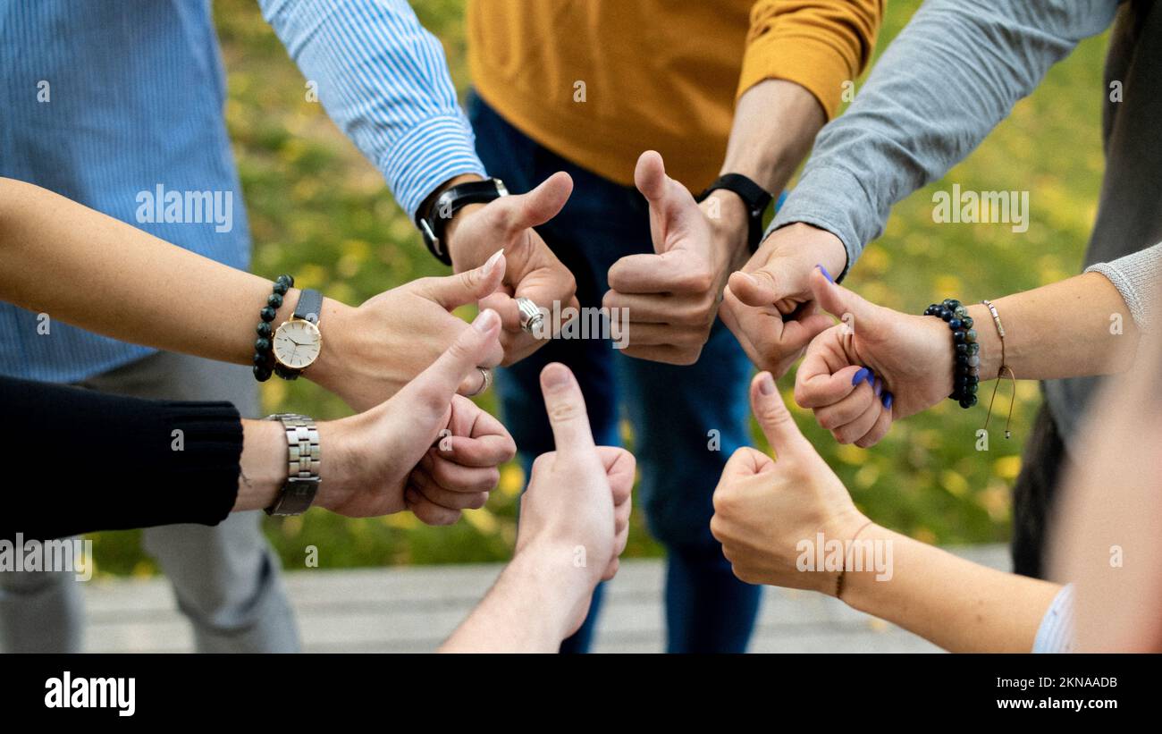 A group of people showing thumbs up together as a teamwork Stock Photo ...