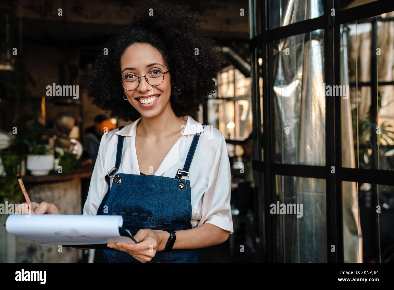 Young african american woman holding clipboard with paper documents ...