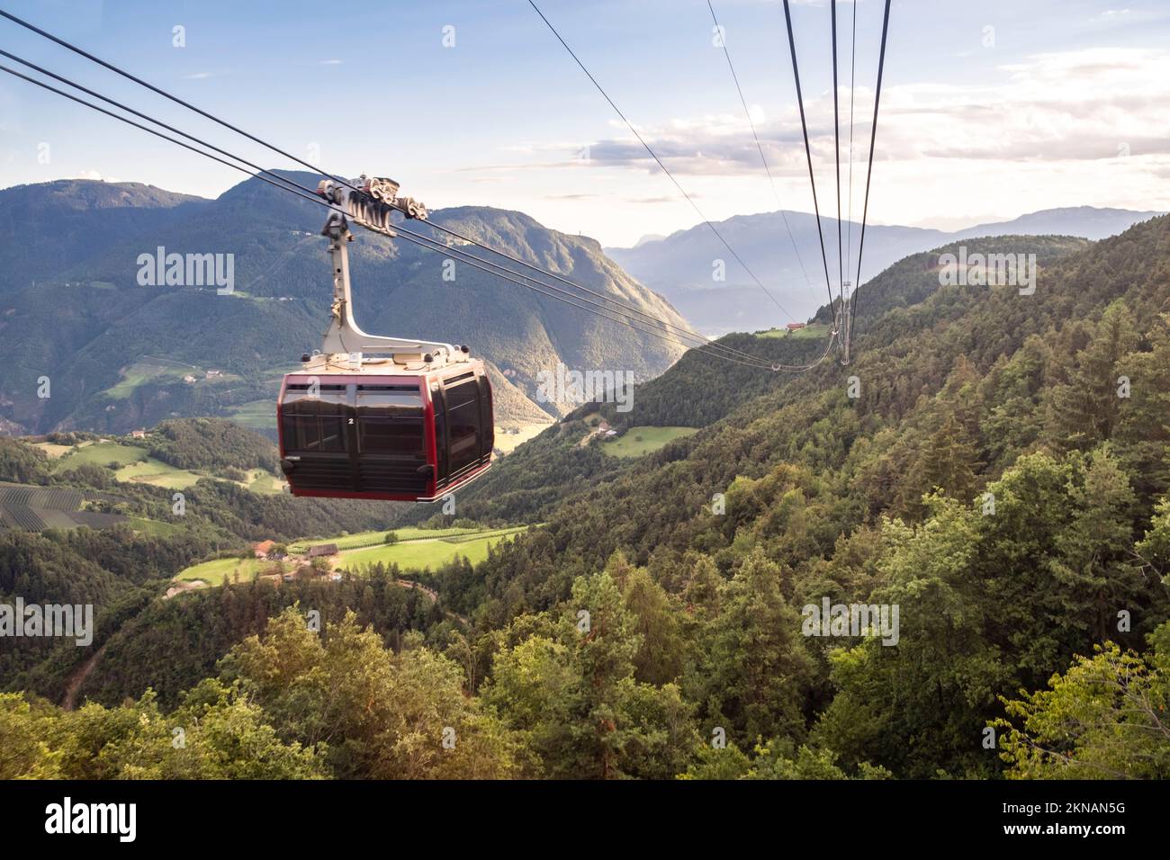 Cable car above valley at sunset. Bolzen, Italy Stock Photo - Alamy