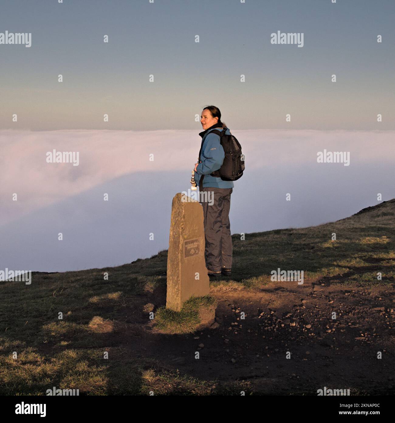 A female walker at the summit of Pule Hill on the Marsden Moor Estate ...