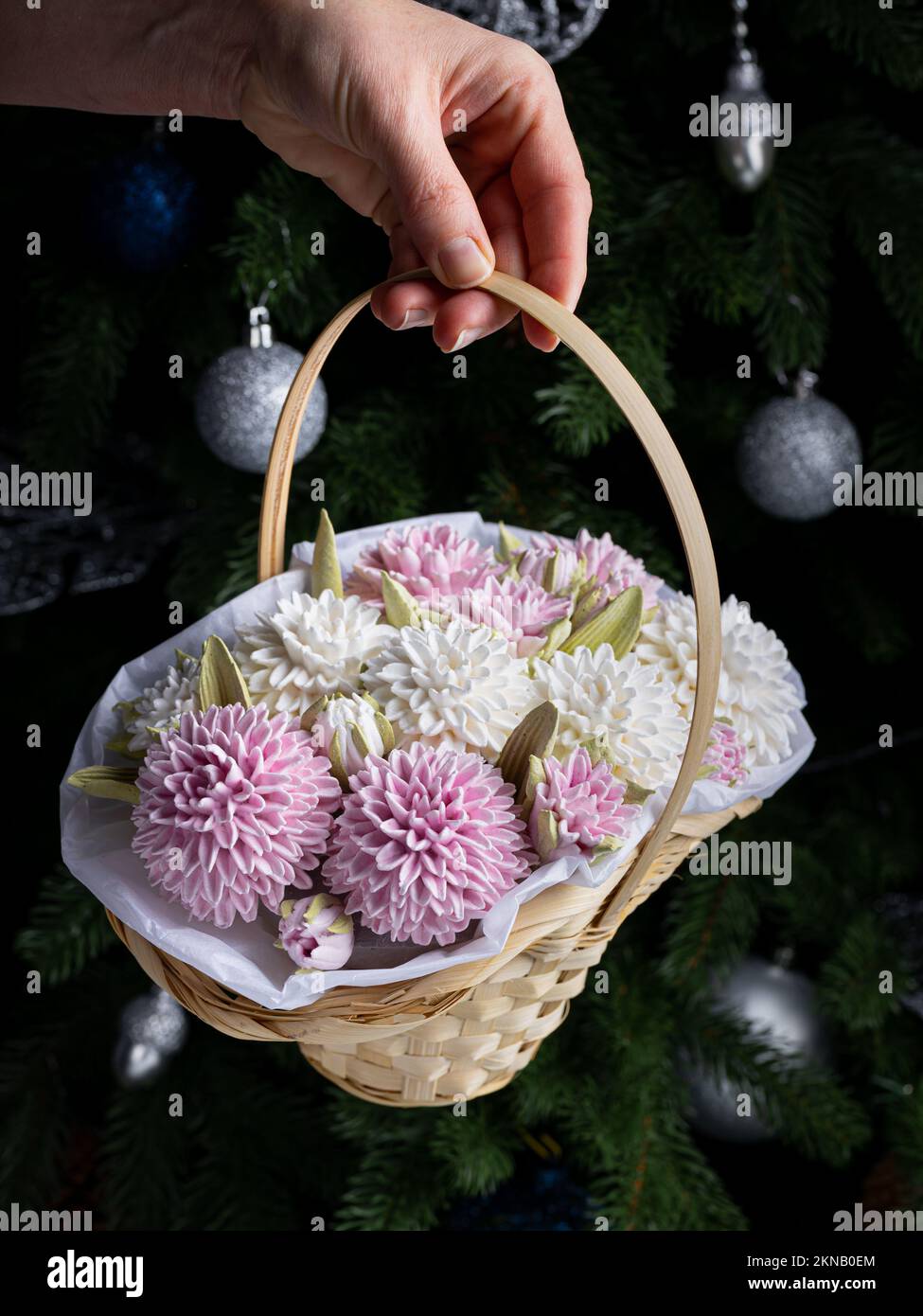 Zephyr bouquet of flowers in a basket on a light background. the ...