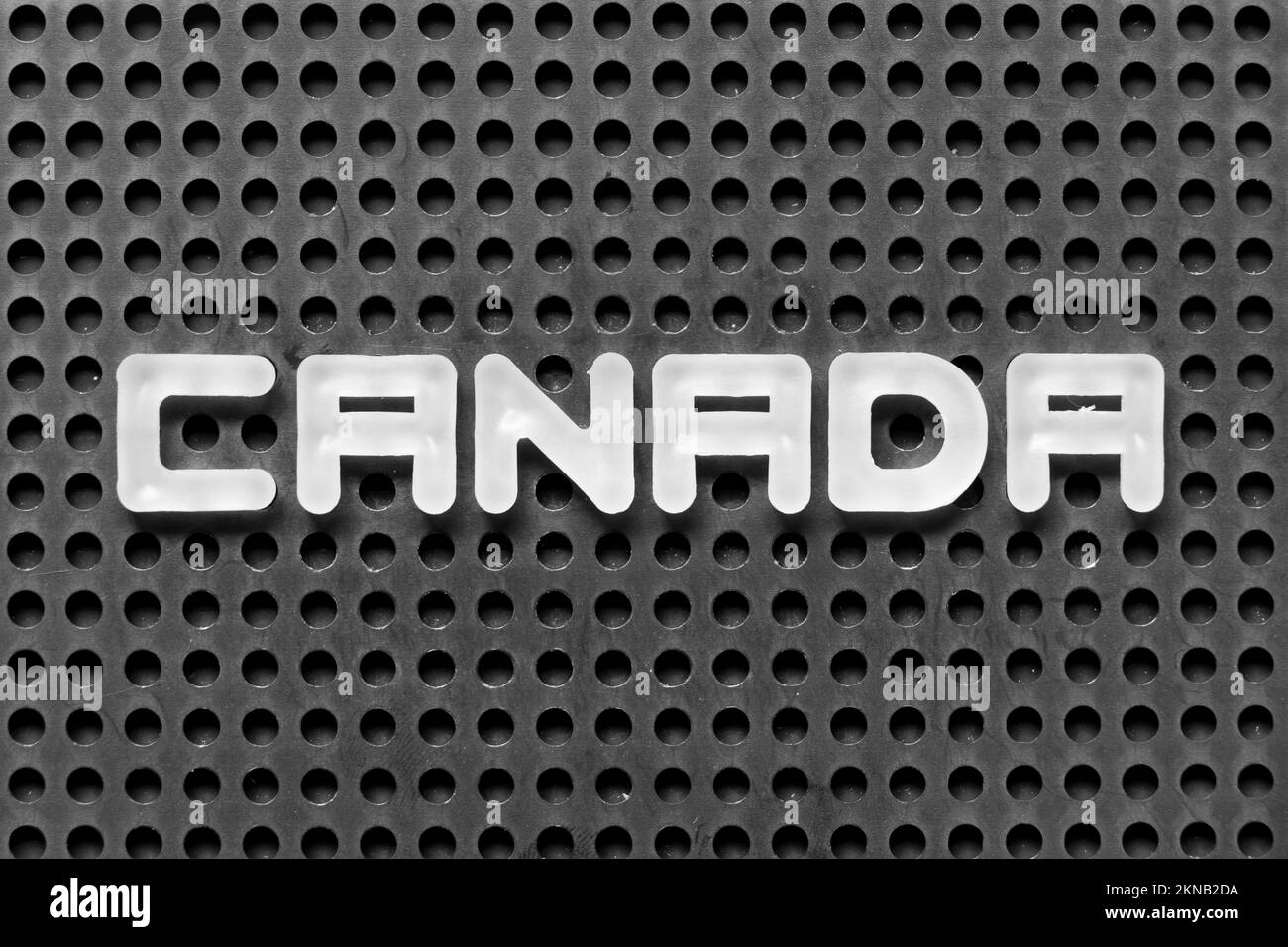 White alphabet letter in word canada on black pegboard background Stock ...