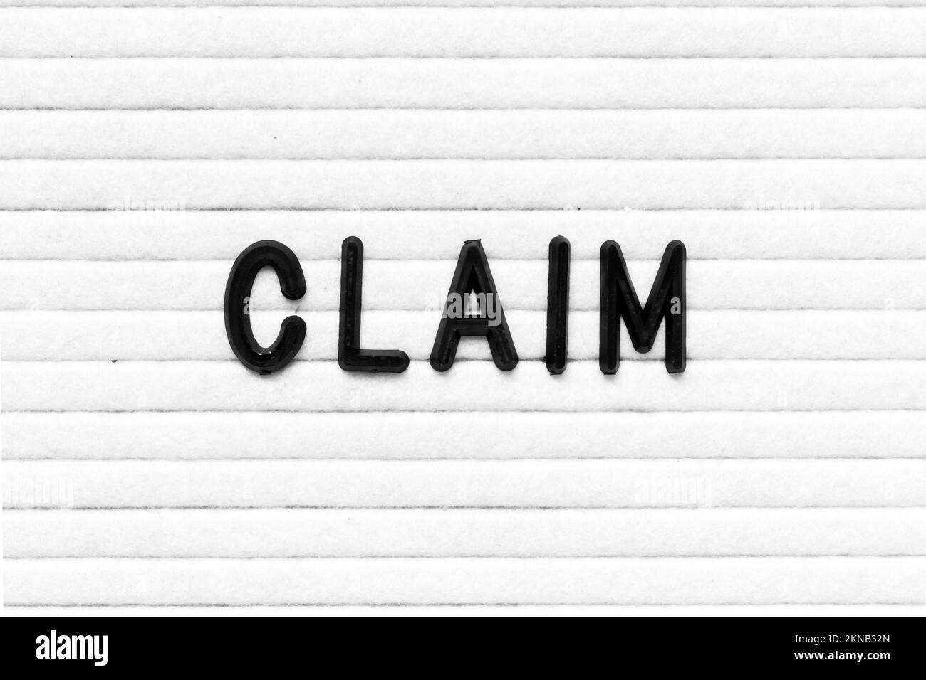 Black color letter in word claim on white felt board background Stock ...