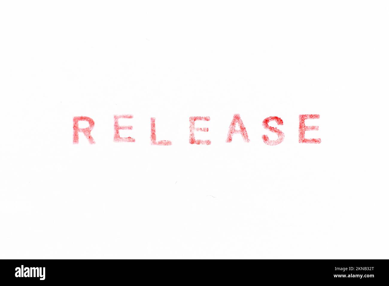 Red color ink rubber stamp in word release on white paper background ...