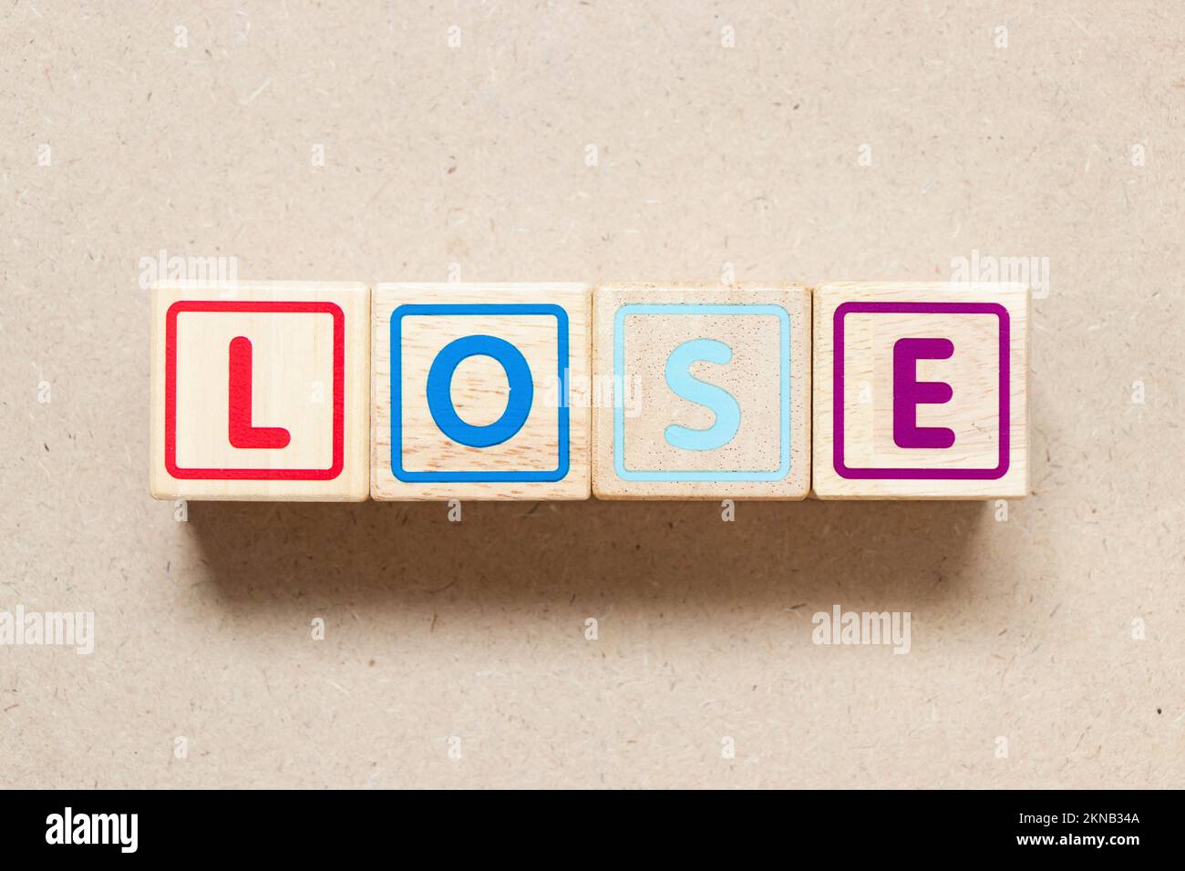 Color letter block in word lose on wood background Stock Photo - Alamy