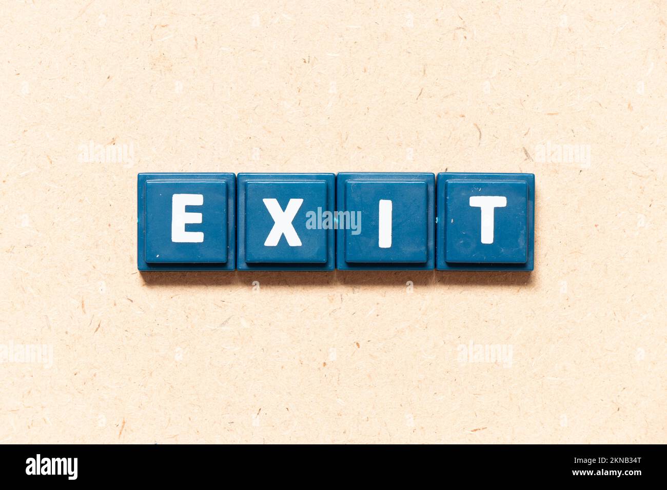 Tile letter in english word exit on wood background Stock Photo - Alamy