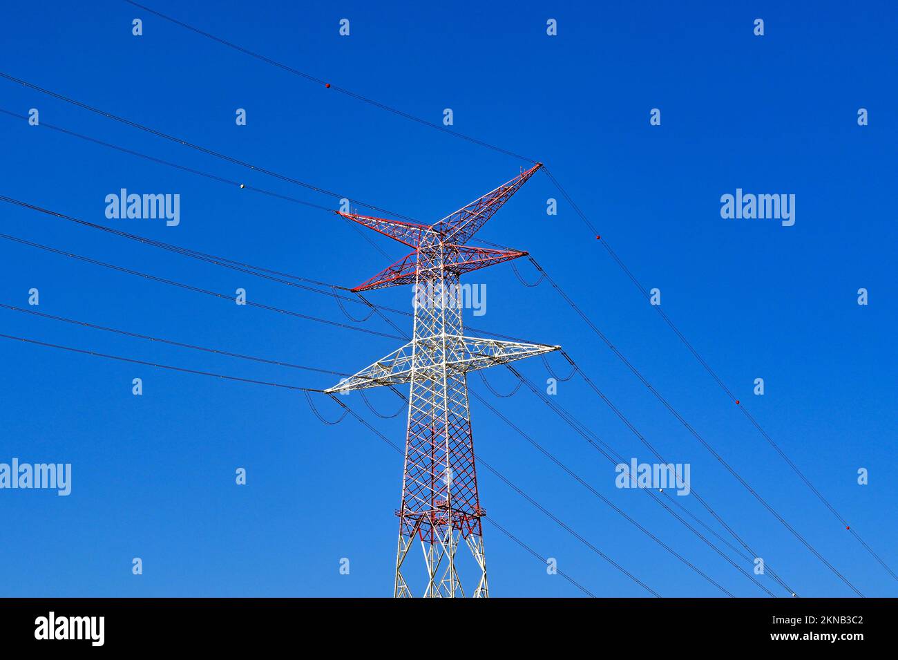 Tall pylon on an electricity supply network isolated against a deep ...