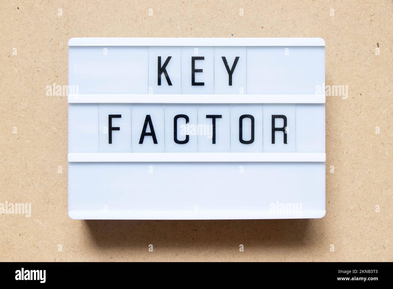 Lightbox with word key factor on wood background Stock Photo - Alamy