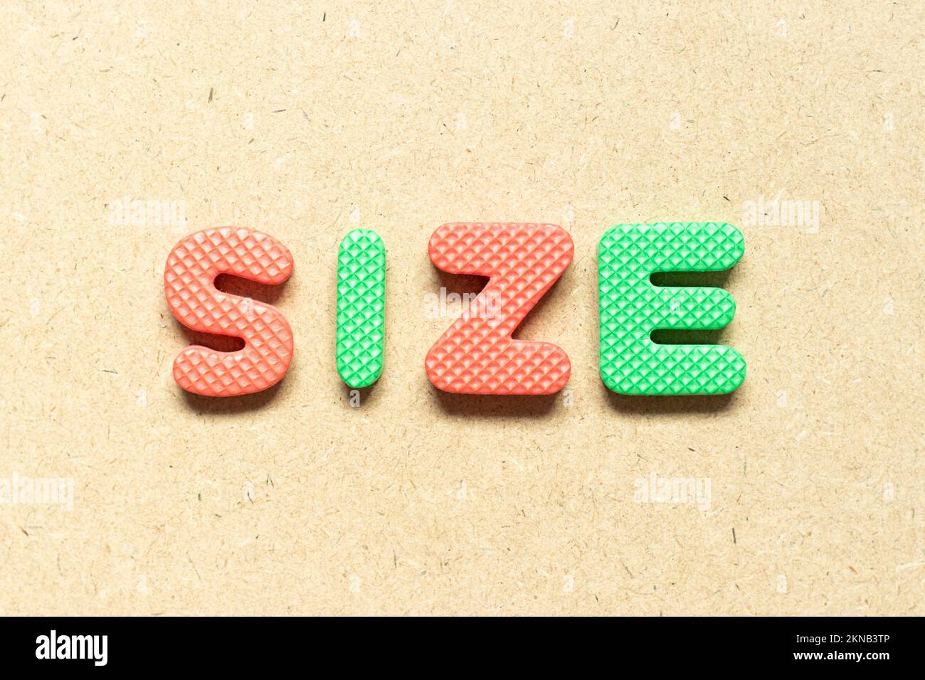 Foam alphabet letter in word size on wood background Stock Photo - Alamy