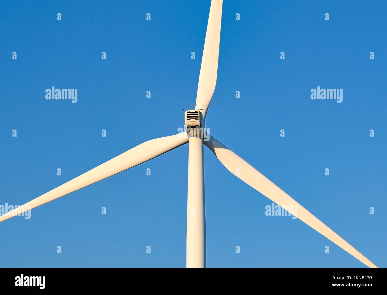 Tall wind turbine isolated against a deep blue sky. No people Stock ...