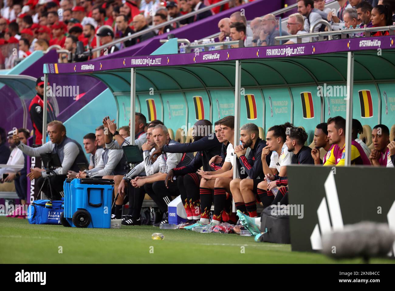 Red Devils' staff members and players on the bench during a soccer game ...
