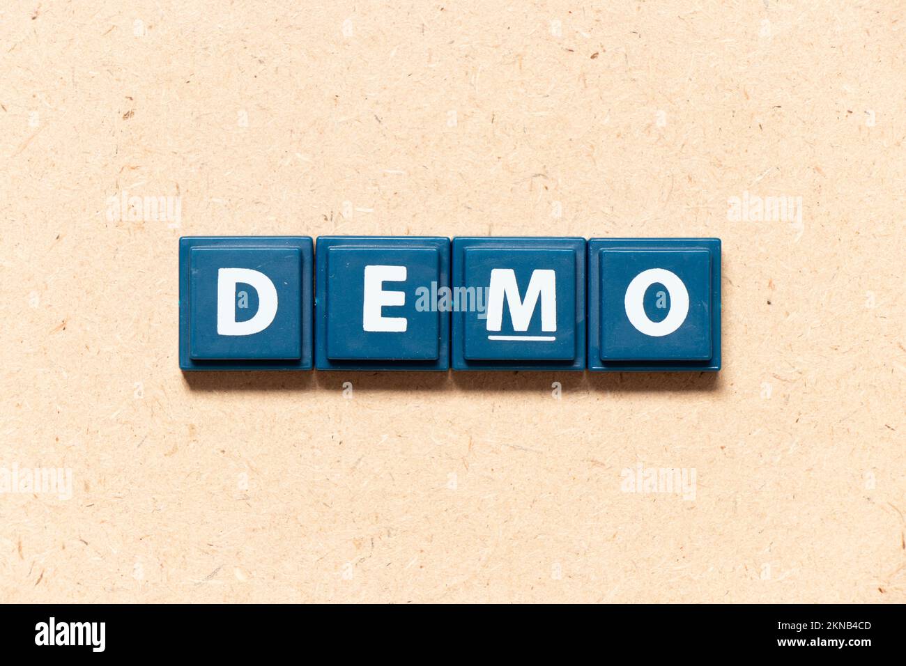 Tile letter in english word demo on wood background Stock Photo - Alamy