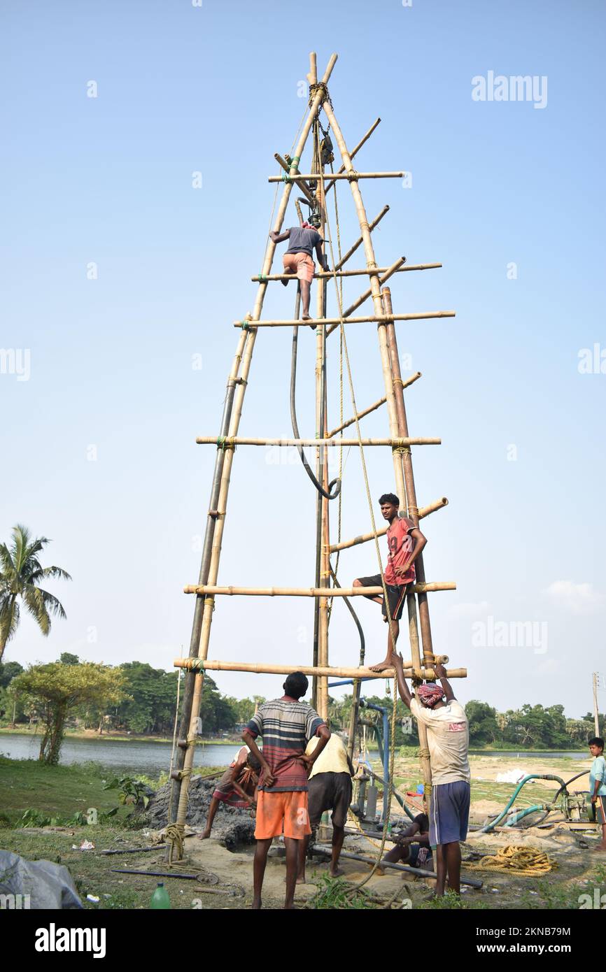 The vertical shot of people building a water pipeline connection before ...